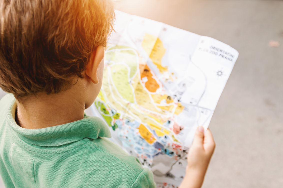 Child reading a map - There We Go